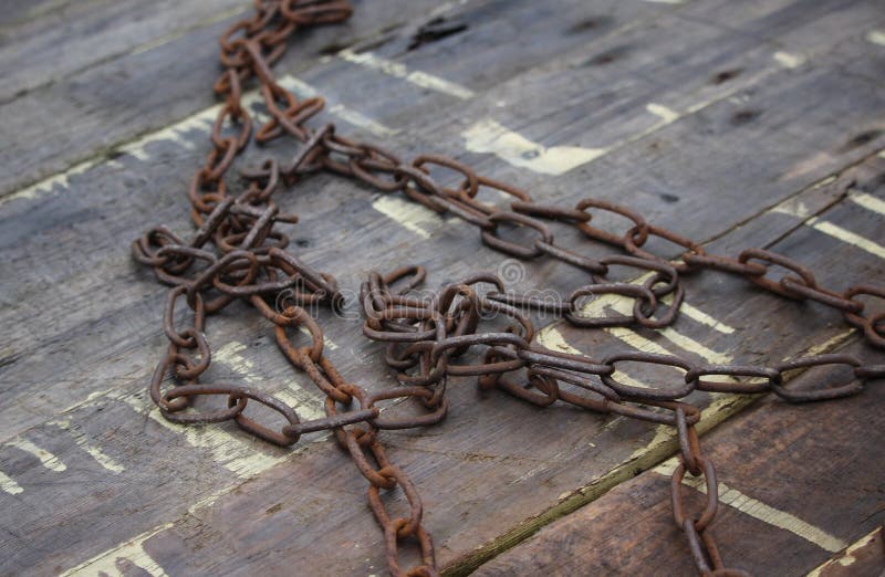 Old Rusted Chain on Weathered Wood. Stock Image - Image of equipment ...