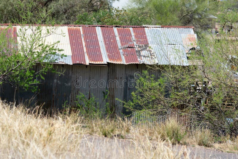 Old Corrugated Metal Building in an Overgrown Yard Stock Image - Image ...
