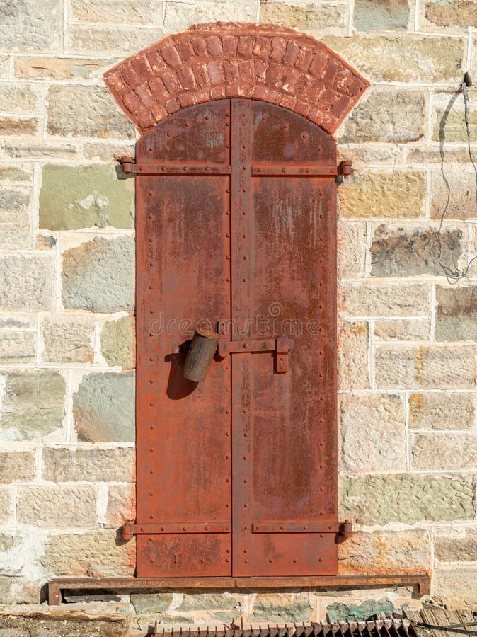 Old Rusted Door with a Stone Wall Surrounding Stock Image - Image of ...
