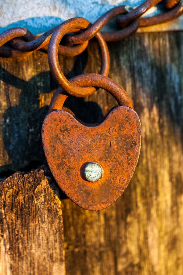 Old Rusted Heart Shaped Padlock on a Loop Chain Stock Image - Image of ...