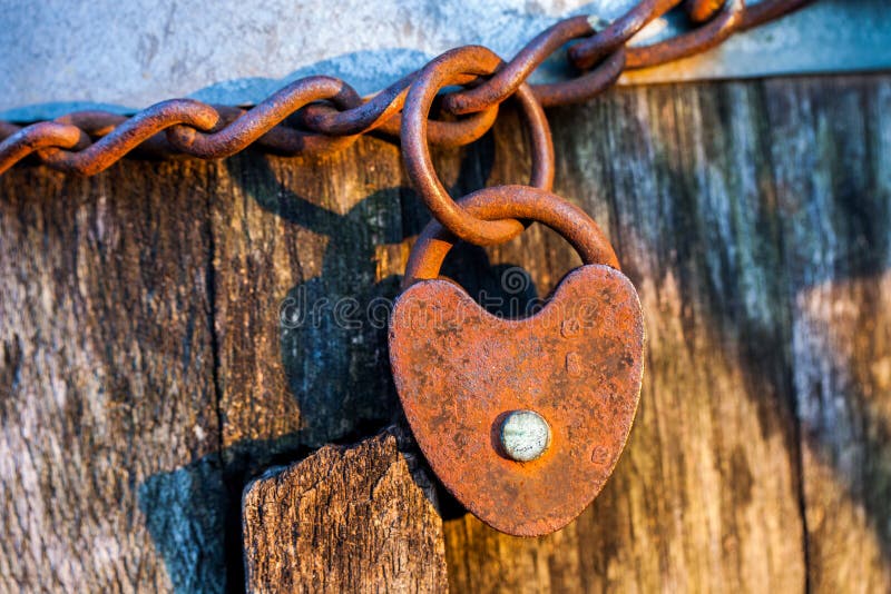 Old Rusted Heart Shaped Padlock on a Loop Chain Stock Image - Image of ...