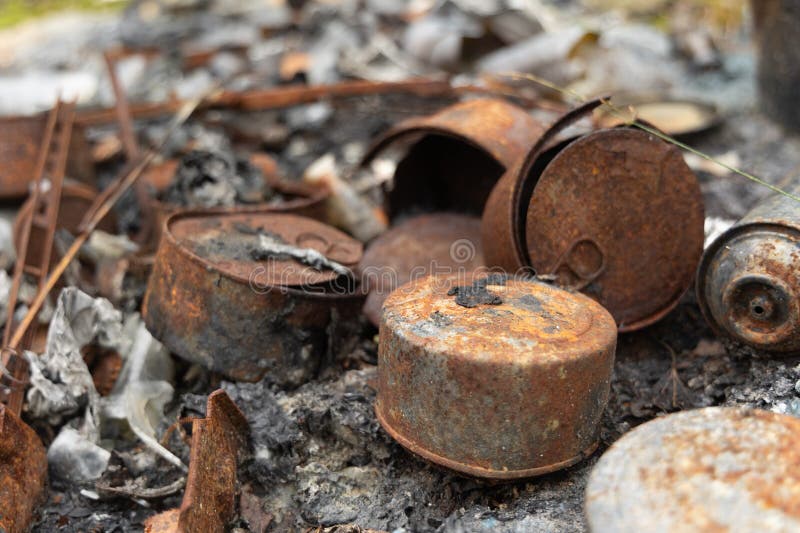 Old, Rusted Metal Cans in Burned Ash. Trash in Abandoned Army Base ...