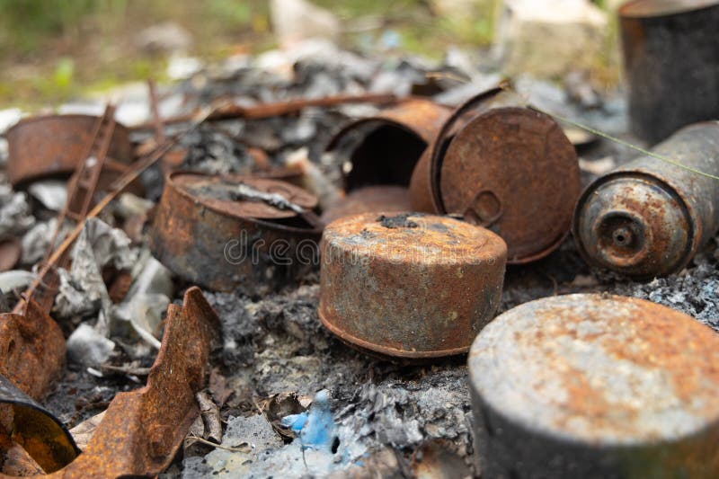 Old, Rusted Metal Cans in Burned Ash. Trash in Abandoned Army Base ...