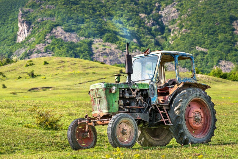 Old rusted tractor parked. stock image. Image of green - 77233547