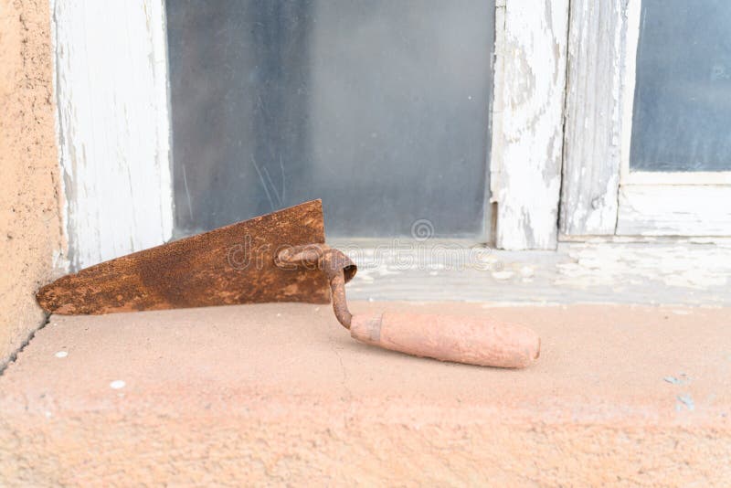 Old Rusted Trowel in Front of an Old Window Stock Photo - Image of ...