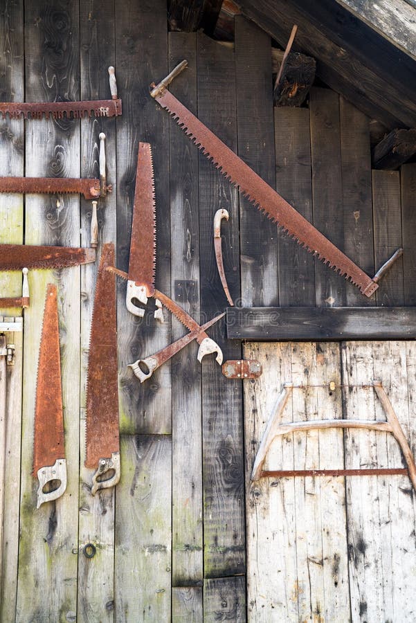 Old Rusted Vintage Saw and Tools Hanging on a Barn Stock Image - Image ...