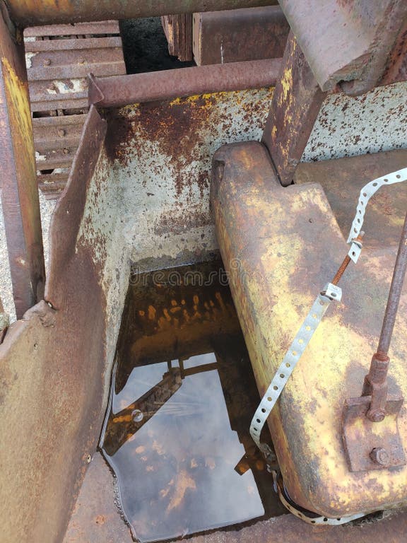 Old Rusted Yellow Machine Puddle Stock Photo - Image of rusted, puddle ...