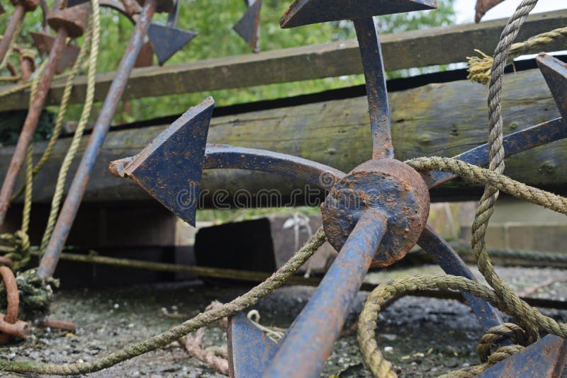 Old rustic anchor on boat stock photo. Image of metal - 259236136