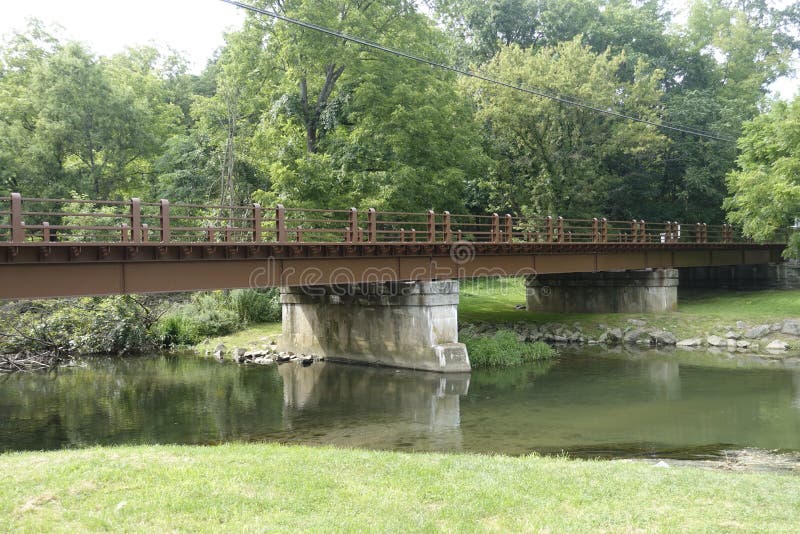 Old Rustic Bridge Of Wooden Planks On A Metal Base With Iron Handrails ...