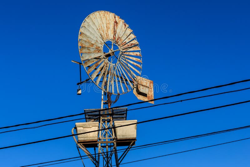 Old Rustic Water Pump Windmill Against Clear Blue Sky Stock Image ...