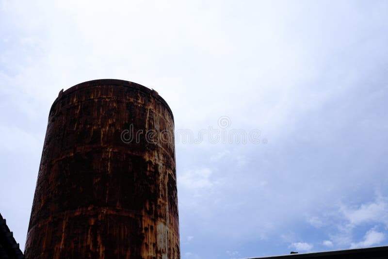 Old Rustic Water Tank with Cloudy Sky Background. Stock Image - Image ...