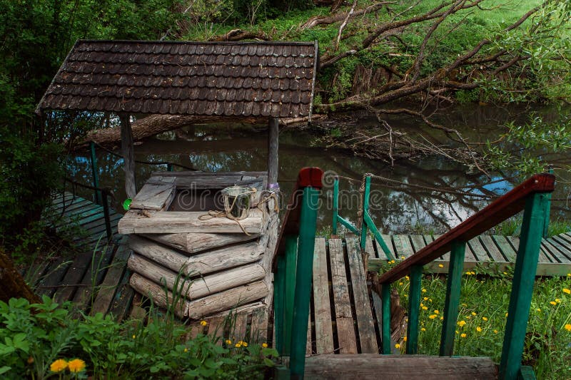 Old Rustic Wooden Well on the River Stock Image - Image of path ...