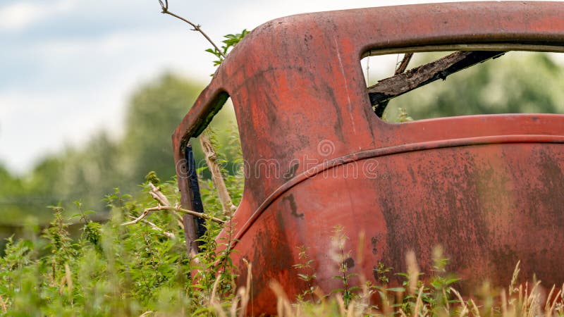 Old Rusting Vintage Car or Barn Find in an Overgrown Field Stock Photo ...