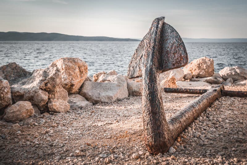 Old Rusty Anchor on the Beach with Stones Stock Photo - Image of ...