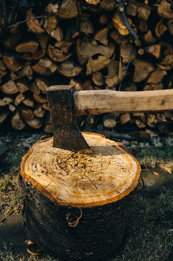 An Old Rusty Axe on the Background of a Stack of Firewood Stock Image ...