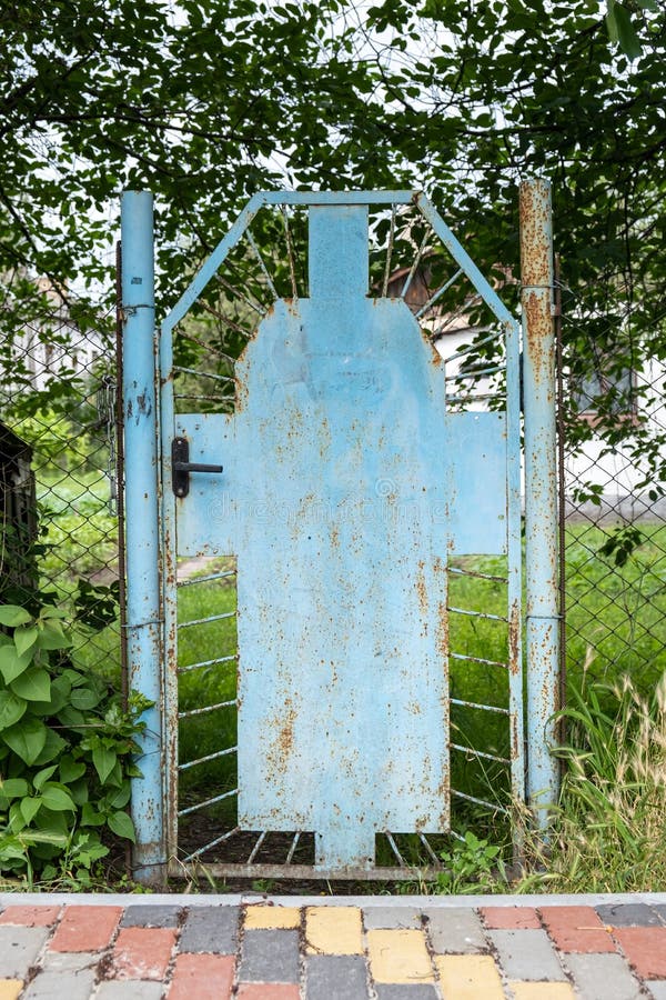An Old Rusty Blue Metal Gate in Front of the Apartment Building Stock ...