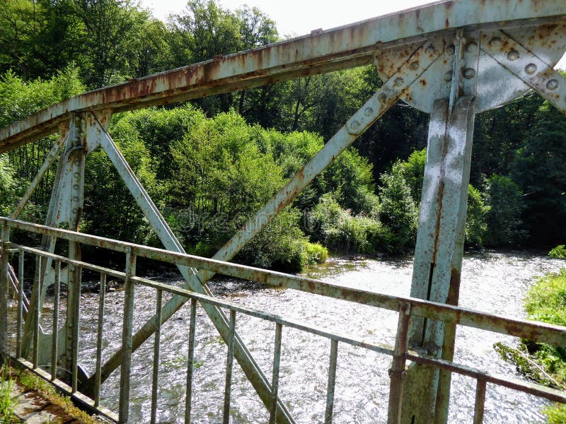 Old Rusty Bridge Over Creek Water. Forest River with Old Bridge Stock ...