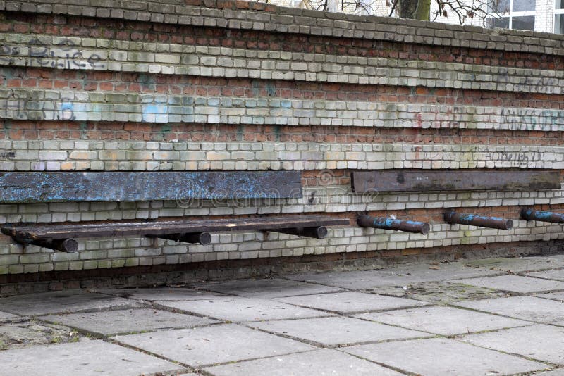 Old Rusty Broken Park Bench on Red Brick Wall Background Stock Photo ...