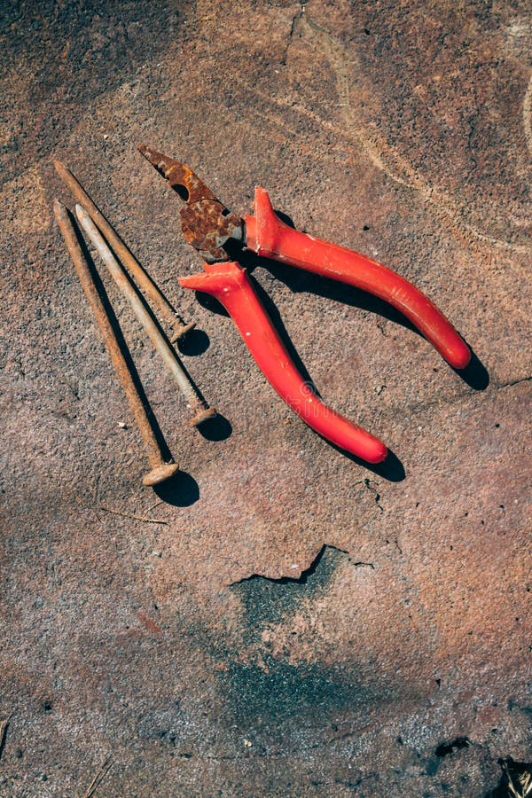 Old Rusty Broken Tools, Nails and Pliers on a Background of Rust Stock ...