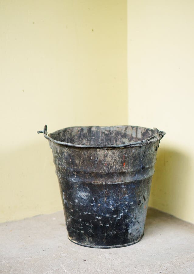 Old rusty bucket by a wall stock image. Image of dirty - 200528745