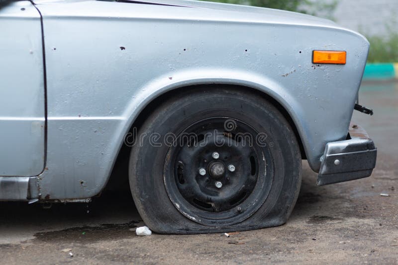 An Old Rusty Car with a Punctured Front Wheel Stock Image - Image of ...