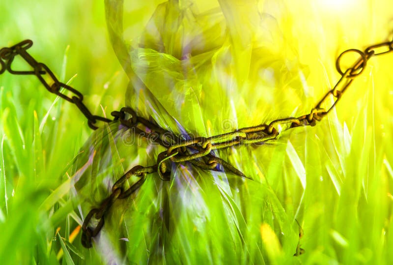 Old Rusty Chains Around the Plastic Bag on Grass Background ...