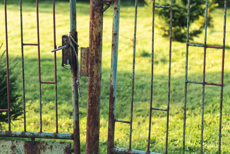 An Old,rusty Closed Gate, Which Leads To a Beautiful Yard Full of Grass ...