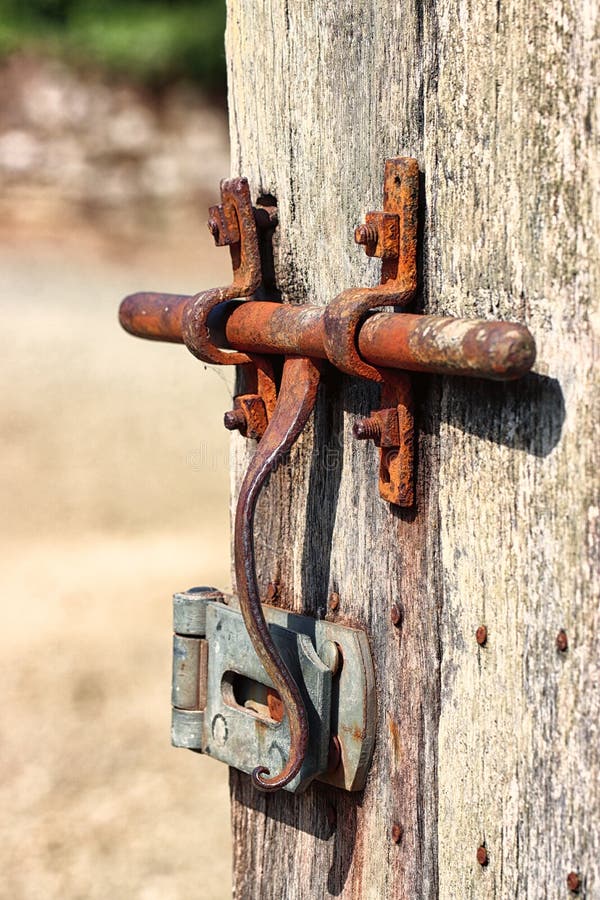Old Rusty Door Bolt on a Rustic Door Stock Image - Image of ancient ...