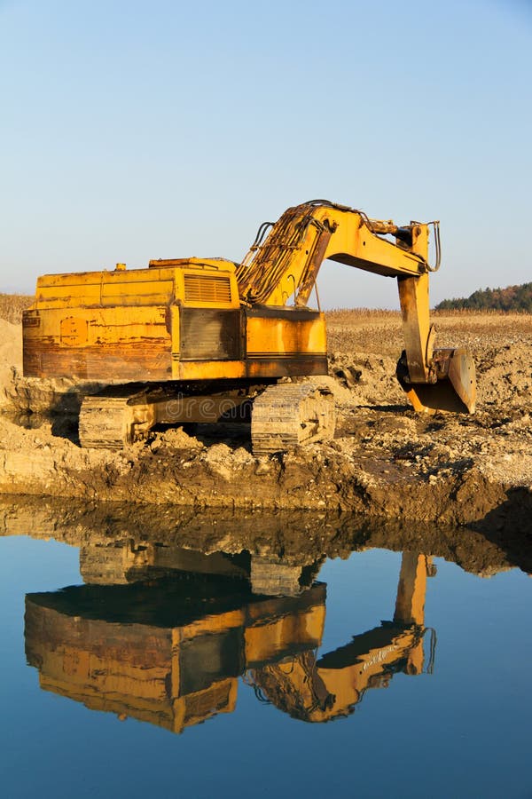 Old Rusty Excavator Digging in the Mud Stock Image - Image of excavator ...