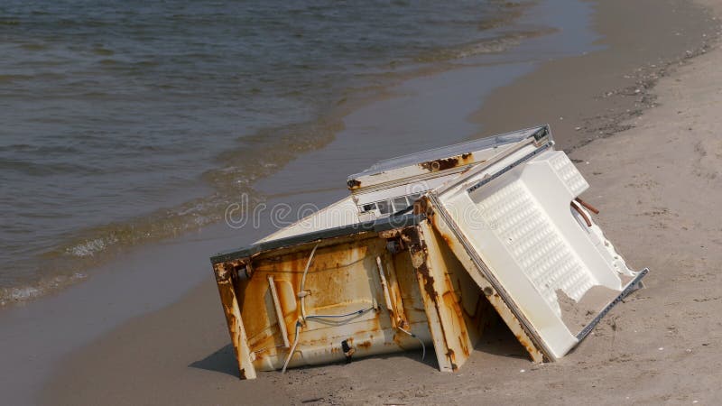 An Old, Rusty Fridge Washed Up on the Beach by the Sea Stock Footage ...