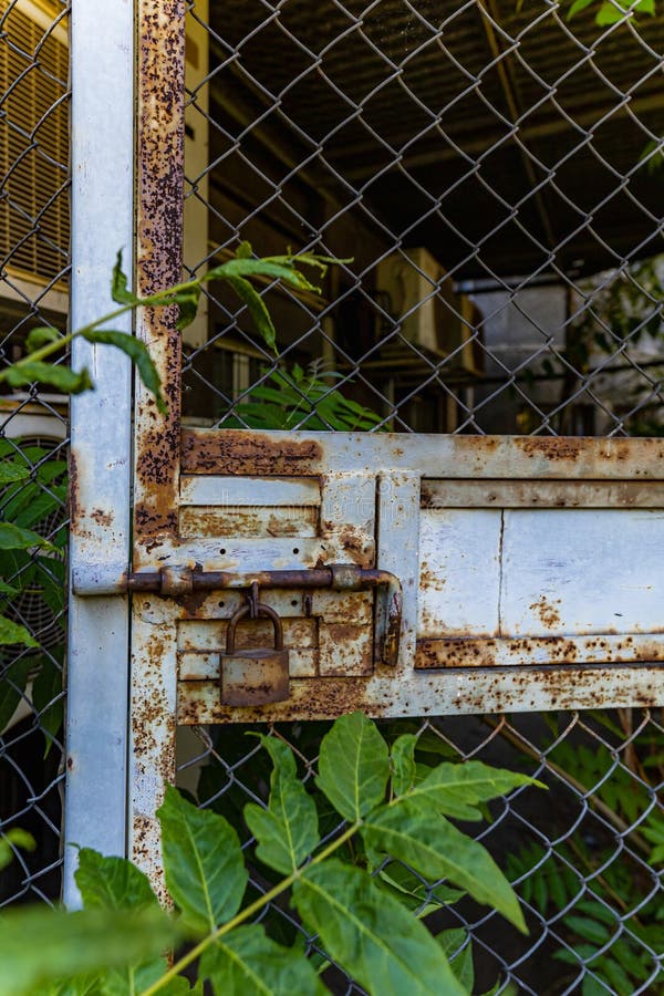 Old Rusty Gate Closed with an Old Rusty Padlock Stock Photo - Image of ...