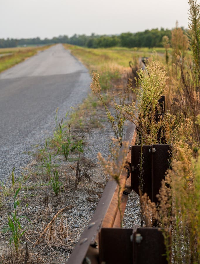 Old Rusty Guardrail Along the Empty Road in the Country Stock Photo ...
