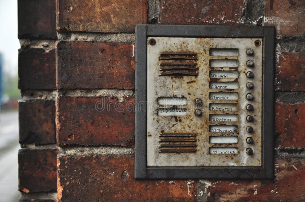 Old Rusty Intercom with Buttons on a Red Brick Wall of a Building Stock ...