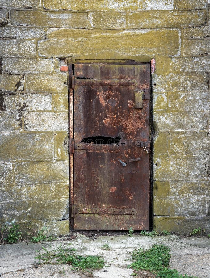 Old Rusty Iron Door in Stone Wall Stock Image - Image of bars, haunted ...