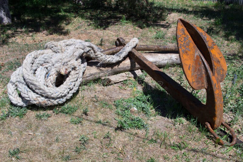 Old Rusty Iron Nautical Ship Ancor with Thick Rope Laying on Ground ...