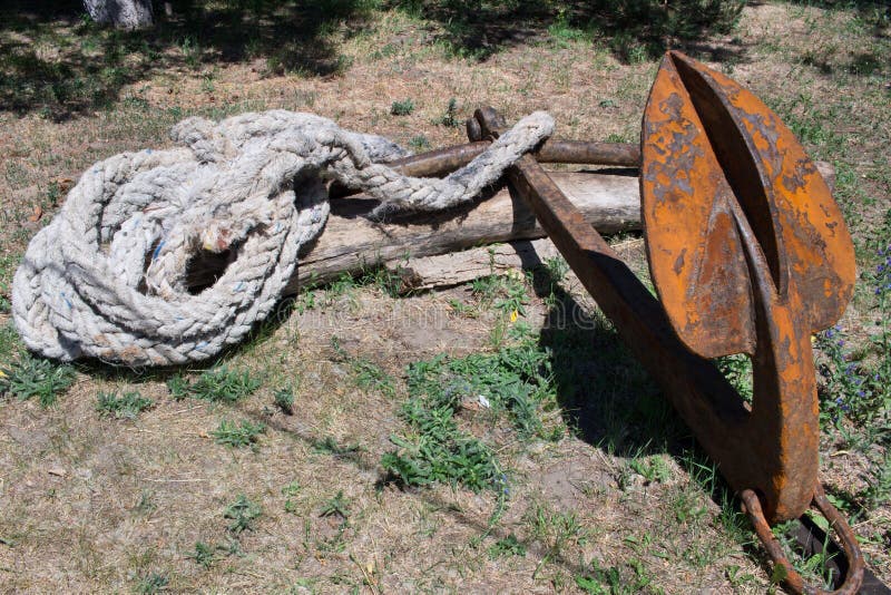 Old Rusty Iron Nautical Ship Ancor with Thick Rope on Ground Stock ...