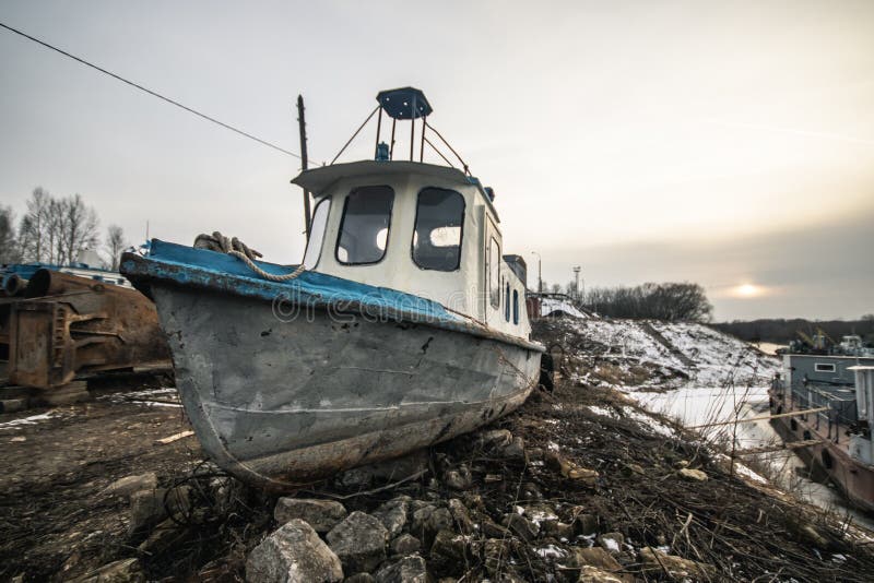 An Old Rusty Iron Ship on the Shore on Rocks in the Old Port on a ...