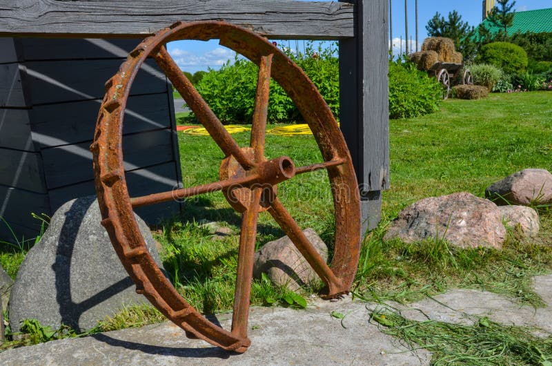 Old Rusty Iron Wheel on a Green Field Stock Image - Image of carriage ...