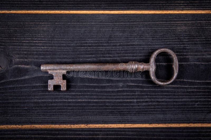 Old Rusty Key on Dark Wood Texture Background Stock Image - Image of ...