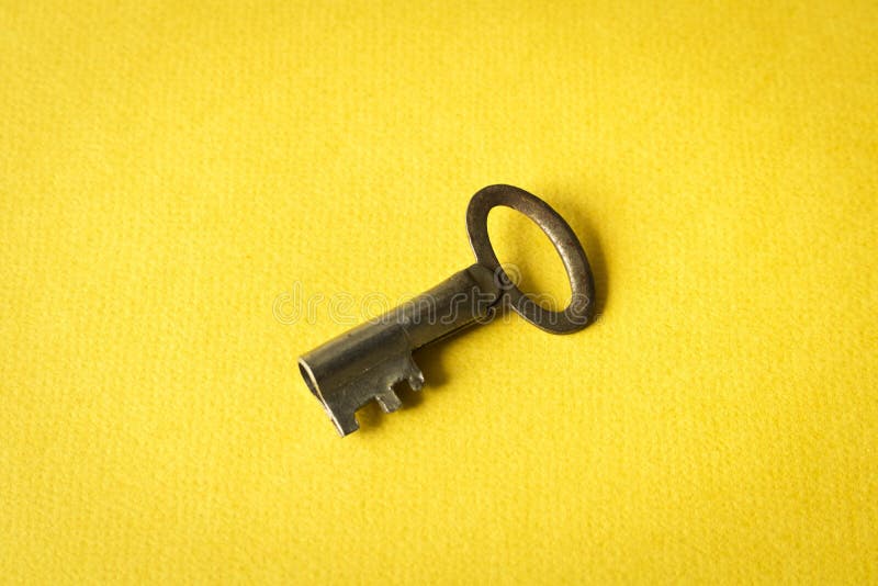 Old Rusty Key on Yellow Background. Key Isolated on Yellow Background ...