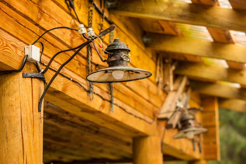 Old Rusty Lamp at the Wood Wall of the House Stock Image - Image of ...