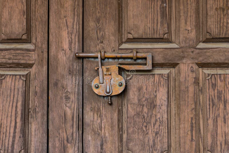 Old Rusty Lock Securing a Rustic Wood Door Stock Image - Image of lock ...