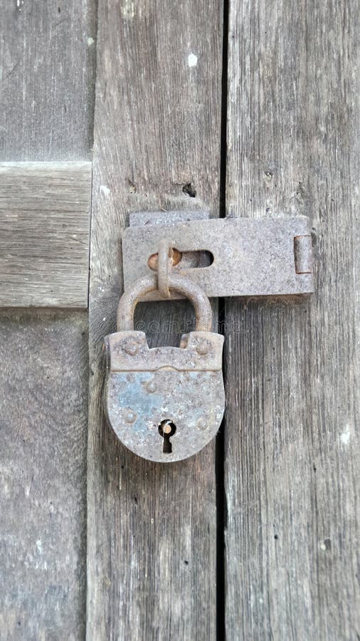 Old and Rusty Lock on Wooden Door of an Abandoned House Stock Image ...
