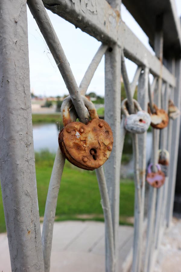 Old Rusty Love Locks on the Bridge Fence Stock Photo - Image of ...