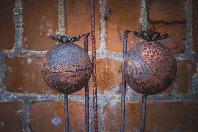 Old Rusty Metal Garden Statue. Red Brick Wall in the Background Stock ...