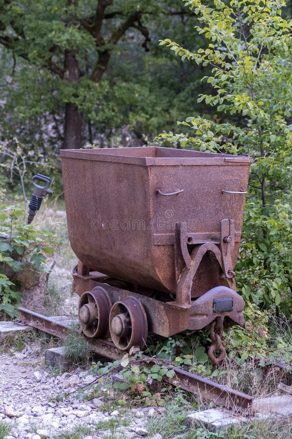 Old Rusty Mining Cart on a Rail Track . Decoration in the Park Stock ...