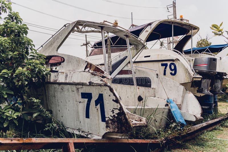 Old and Rusty Motor Boats on a Landfill Surrounded by Tropical Forest ...