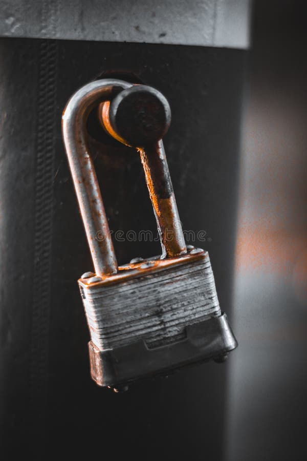 Rusted Padlock Attached To Pole with Blurred Background Stock Photo ...