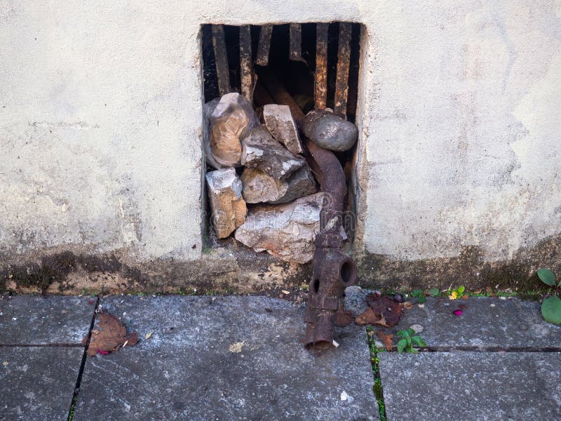 An Old Rusty Pipe Comes Out of the Basement of a Building. Old ...