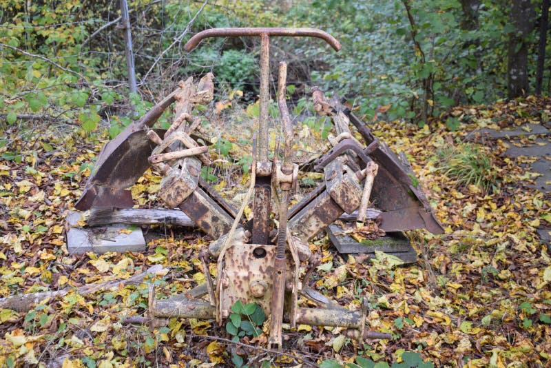 Old Rusty Plow in the Forest Resting on Concrete Stock Photo - Image of ...